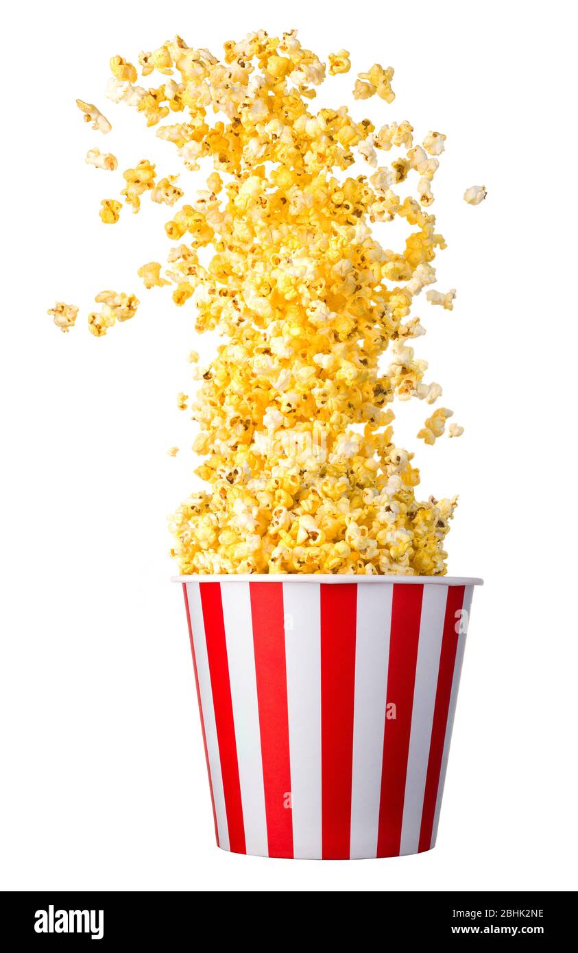 Flying popcorn from paper striped bucket isolated on black background ...