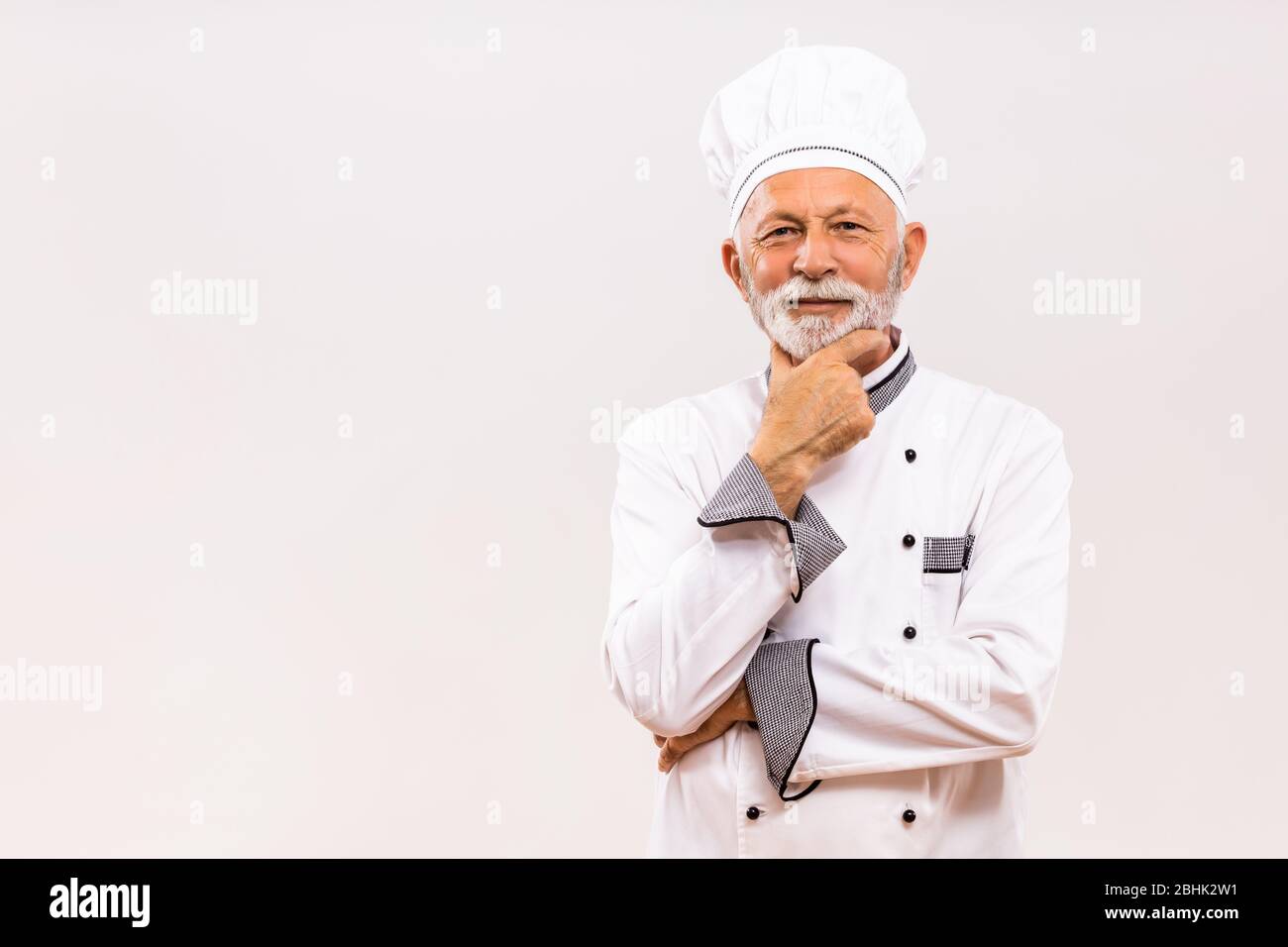 Portrait of senior chef thinking on gray background Stock Photo - Alamy