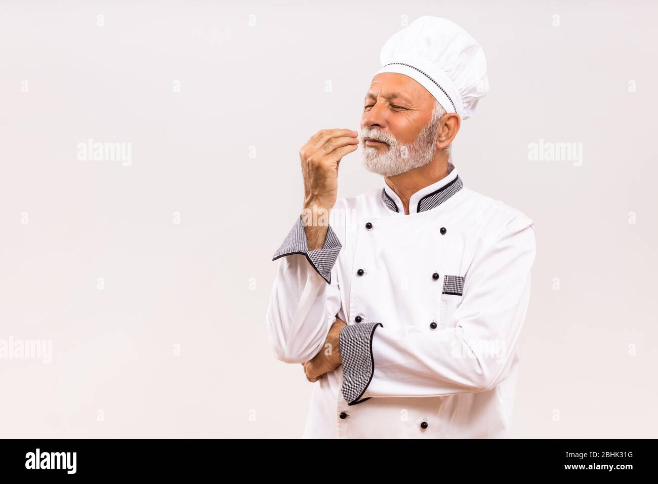 Portrait of senior chef delicious sign Stock Photo - Alamy