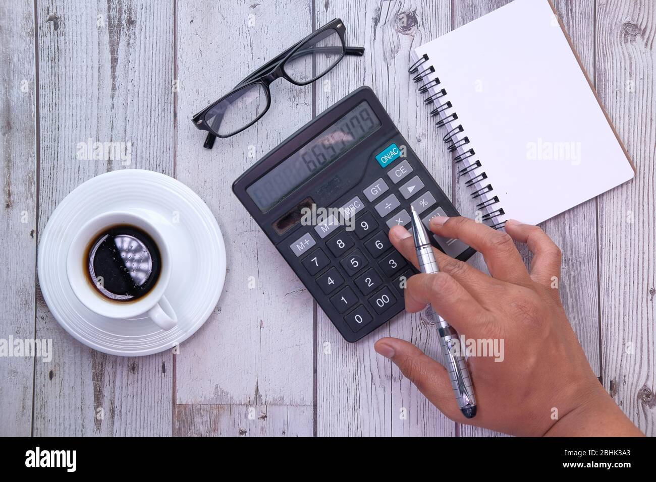 man hand using calculator on offie desk Stock Photo - Alamy