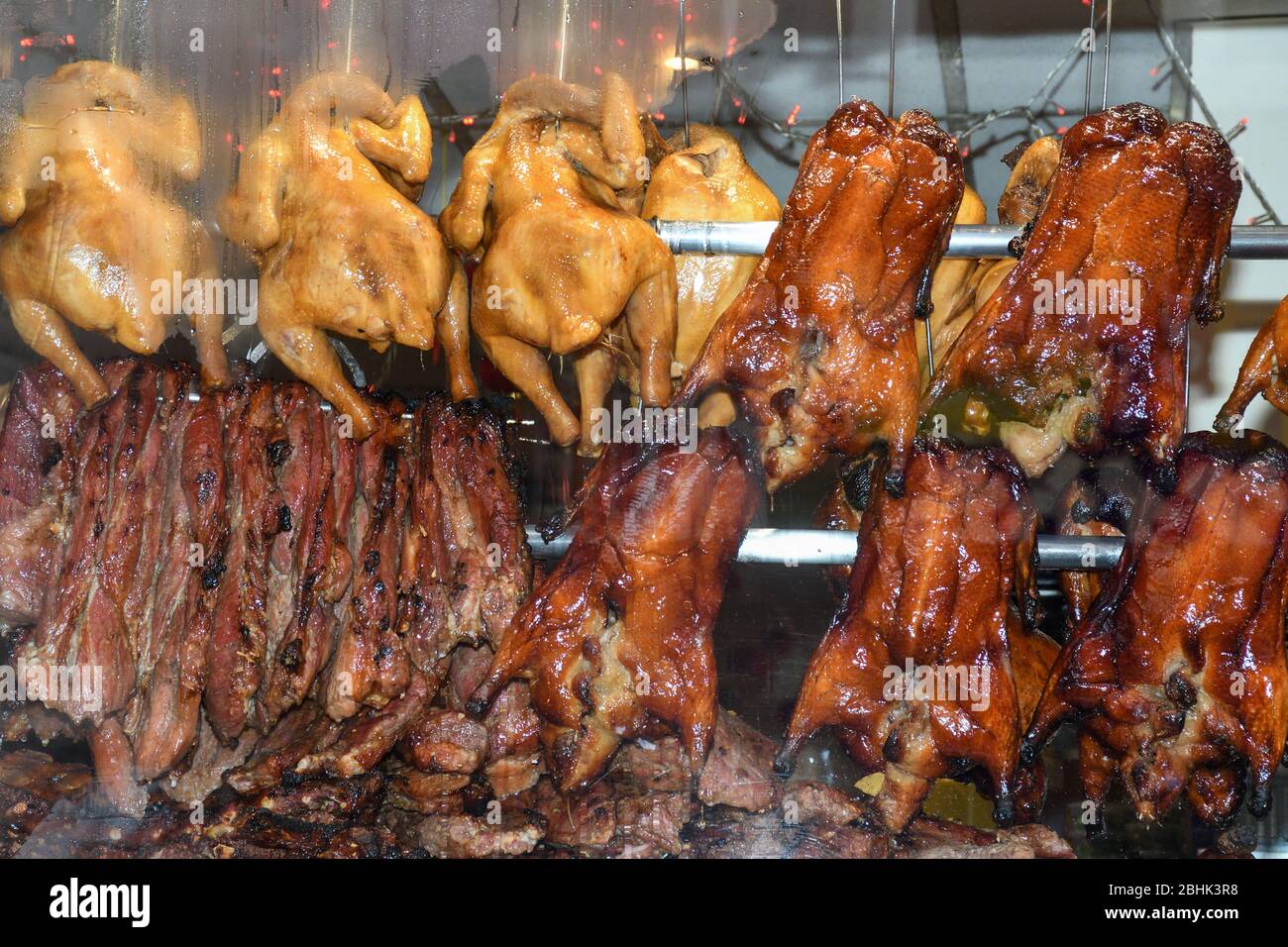 Roasted ducks hanging on rack showcase in restaurant's kitchen Stock ...