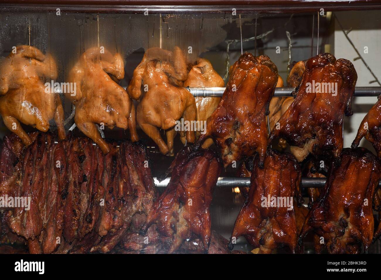 Roasted ducks hanging on rack showcase in restaurant's kitchen Stock ...