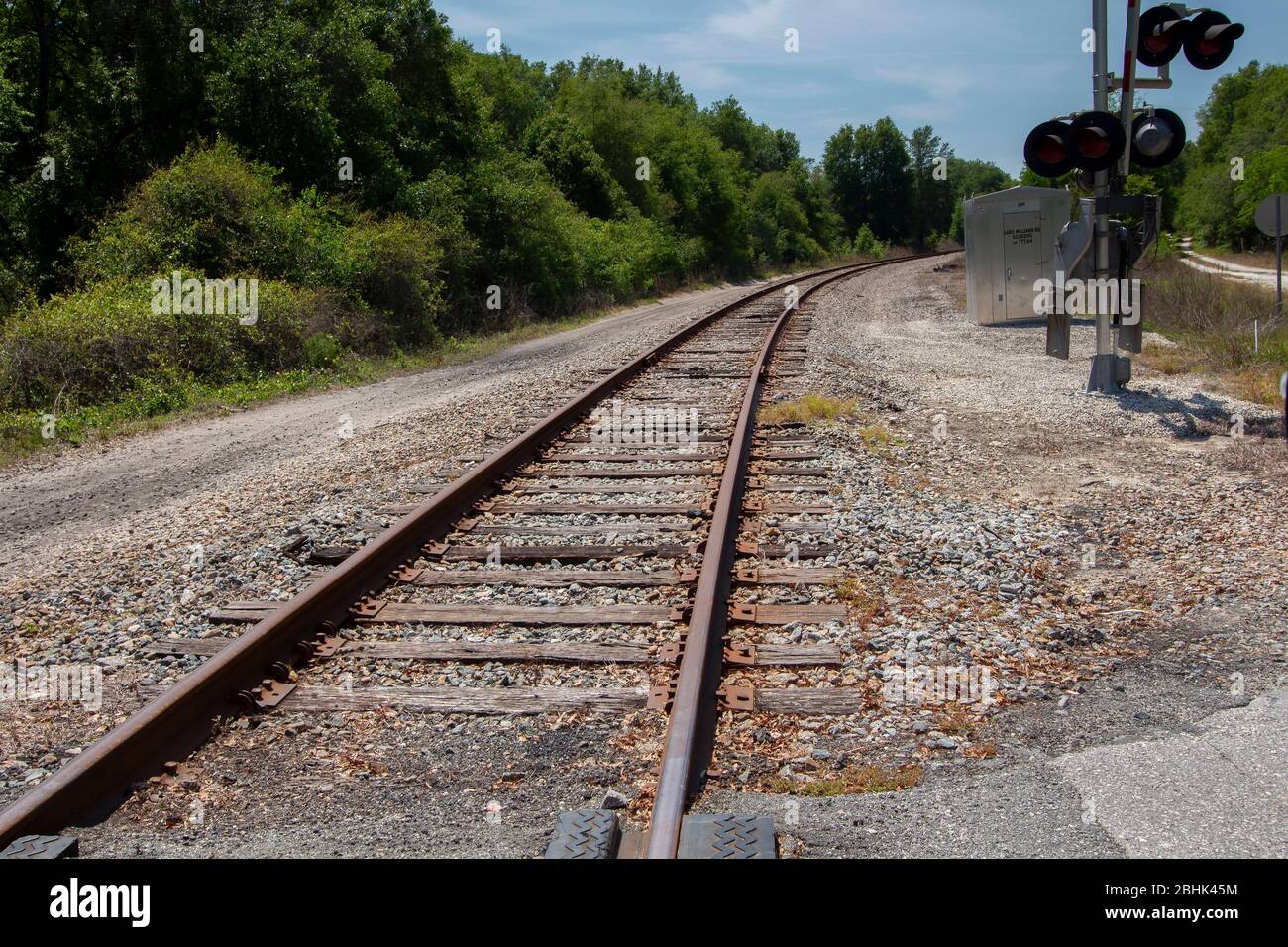 Railroad tracks at a crossing Stock Photo - Alamy