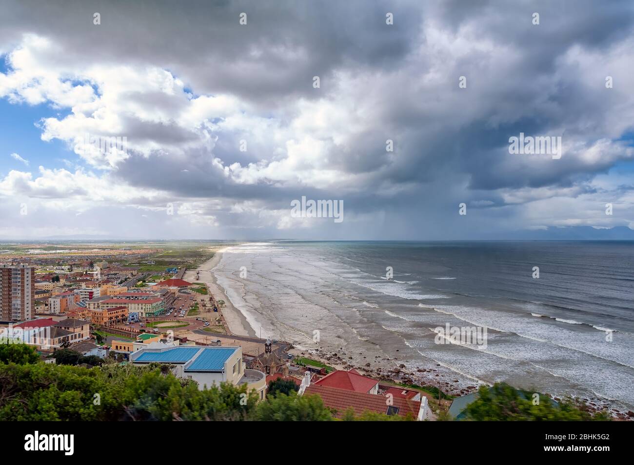 View of Muizemberg beach under stormy sky. Muizenberg is a beach-side ...
