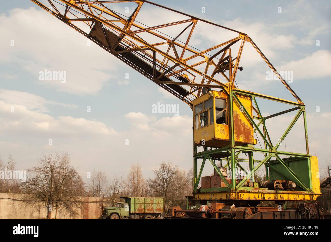 Rusty crane on sky background, shooting in early spring on a sunny day ...