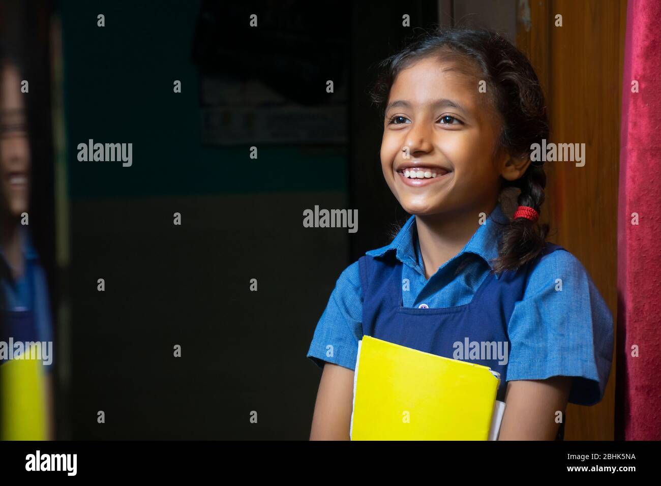 Portrait of a young school girl smiling Stock Photo - Alamy