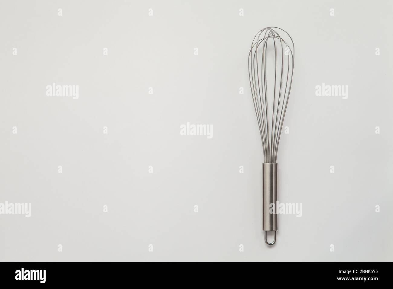 Metal whisk for whipping on a white background Stock Photo - Alamy