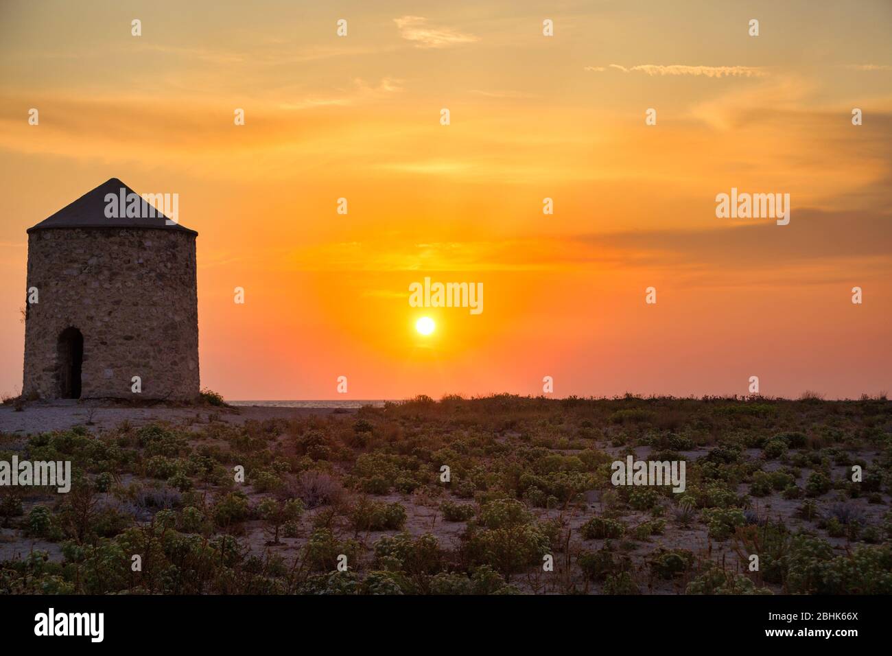 Beautiful sunset at Agios Ioannis (Gyra) beach which is famous for old ...