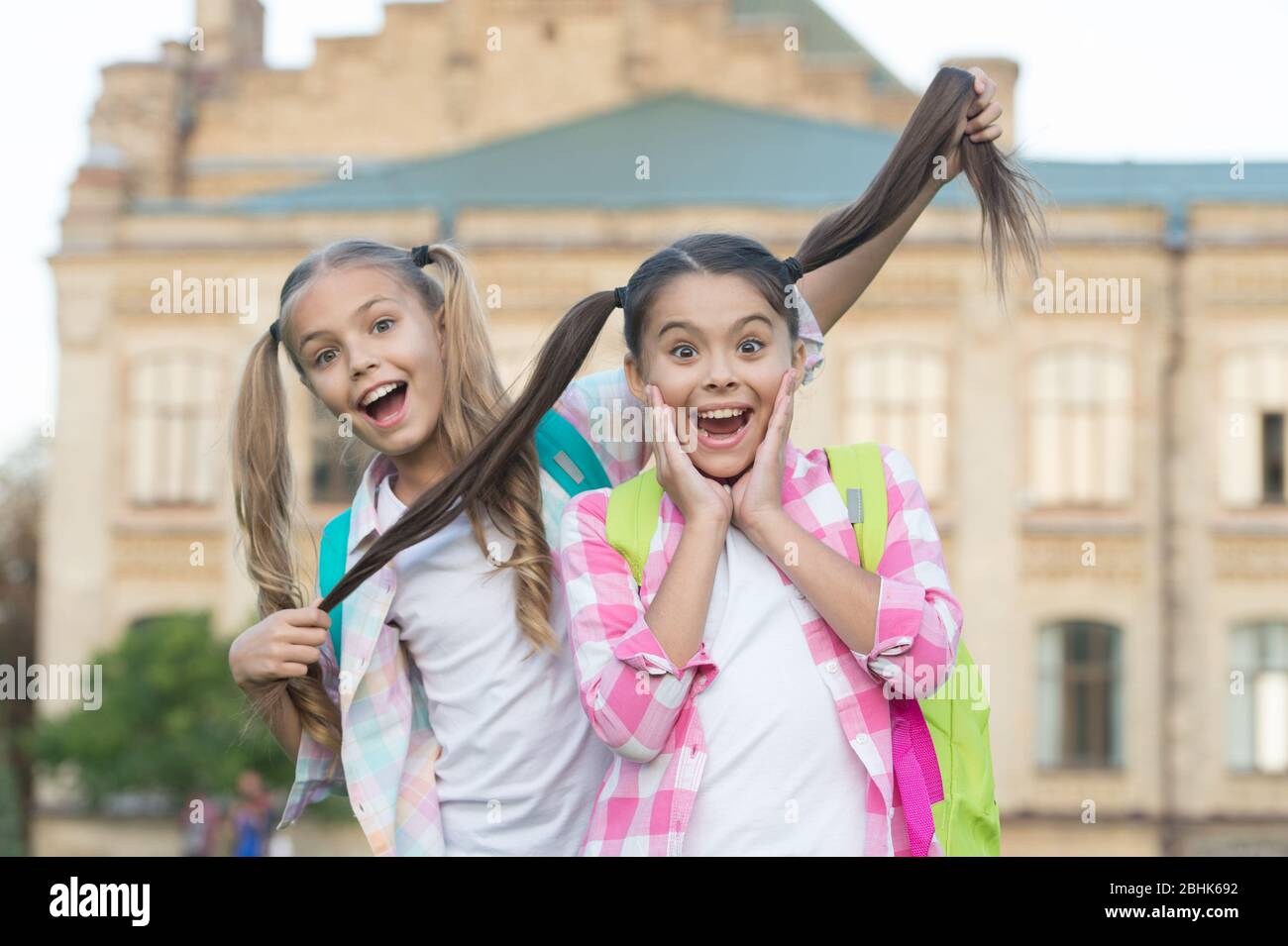 Keep your hair long. Happy children hold long hair. School girls in ...