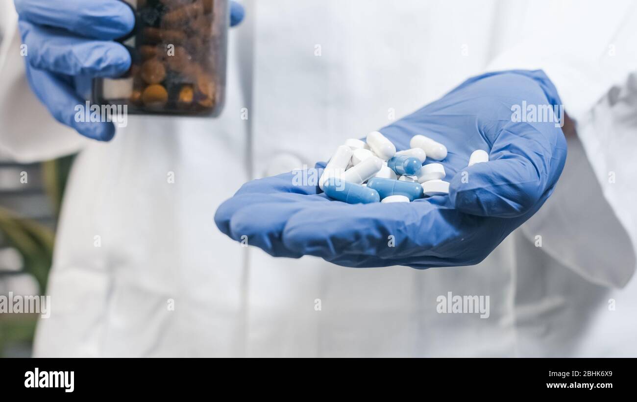 Many medical pills in doctor hands with bottle. Closeup 4k Stock Photo ...