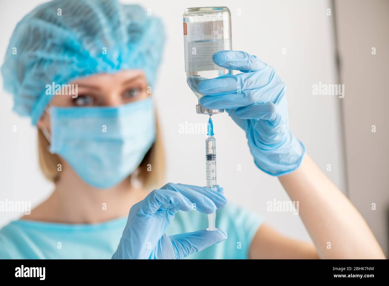 Bottle and syringe for injection in nurse hand. Medical glass vial for ...