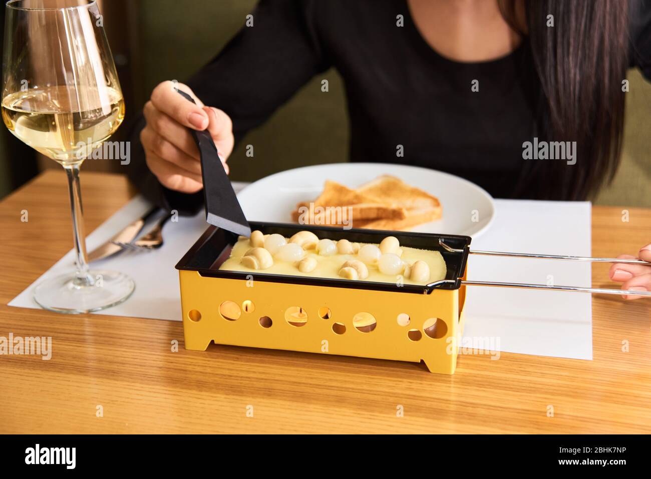 swiss food. cheese raclette with mushrooms on coupelles - special small ...