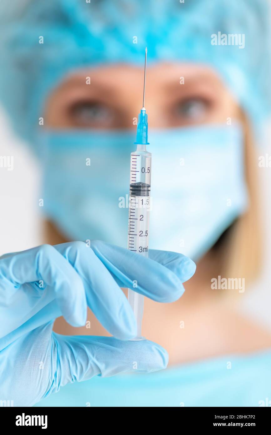 Syringe for injection in nurse hand. Medical glass vial for vaccination ...