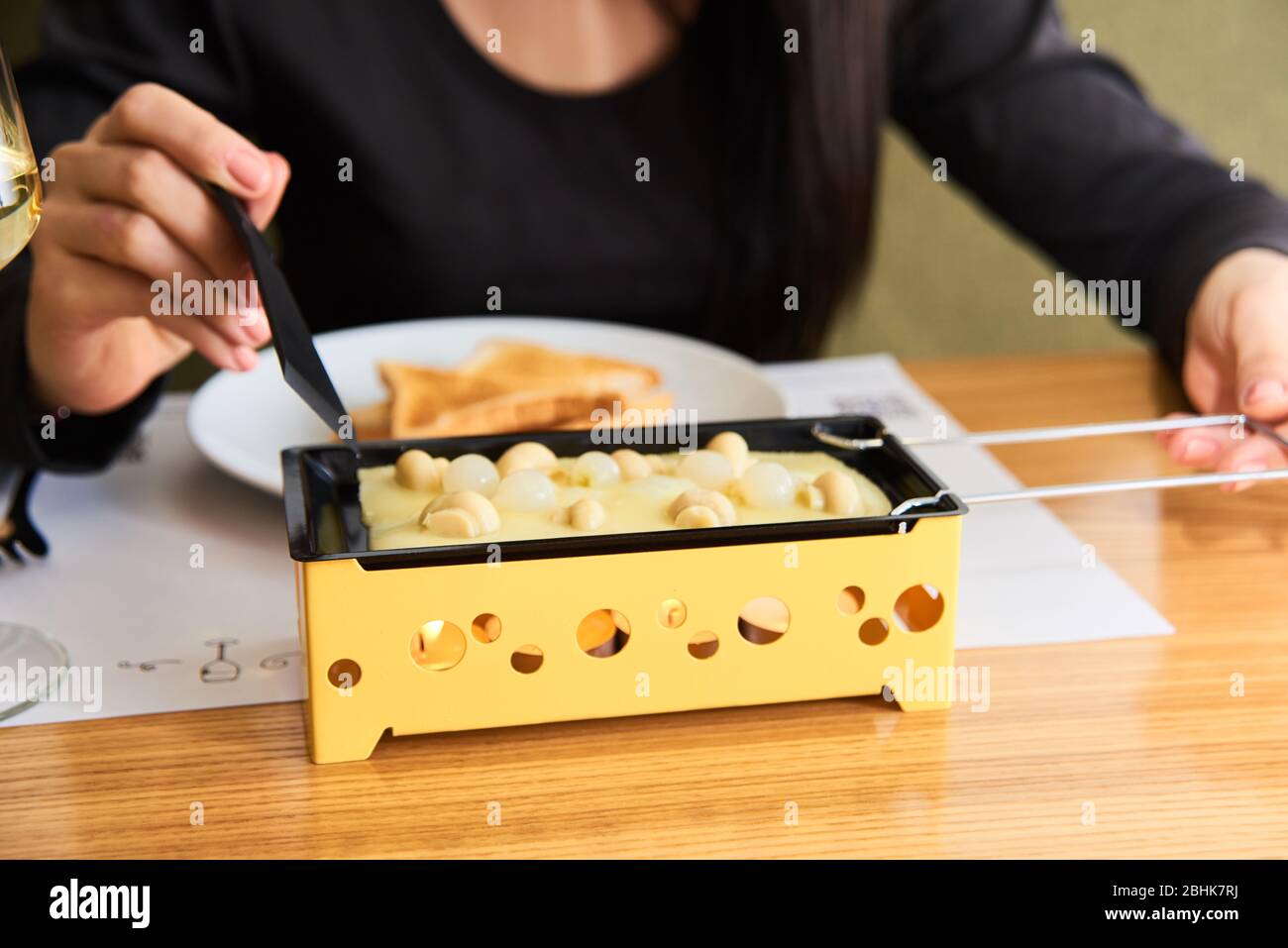 swiss food. cheese raclette with mushrooms on coupelles - special small ...