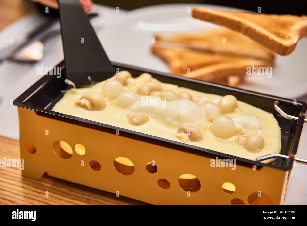 swiss food. cheese raclette with mushrooms on coupelles - special small ...
