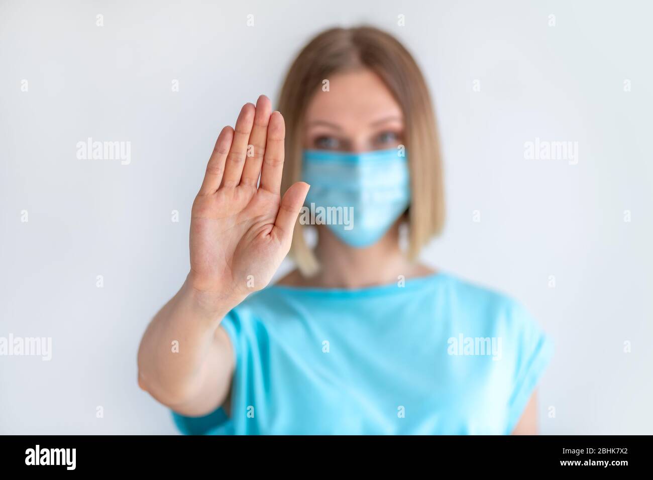 Attractive female nurse showing stop sign with his hand gesture ...