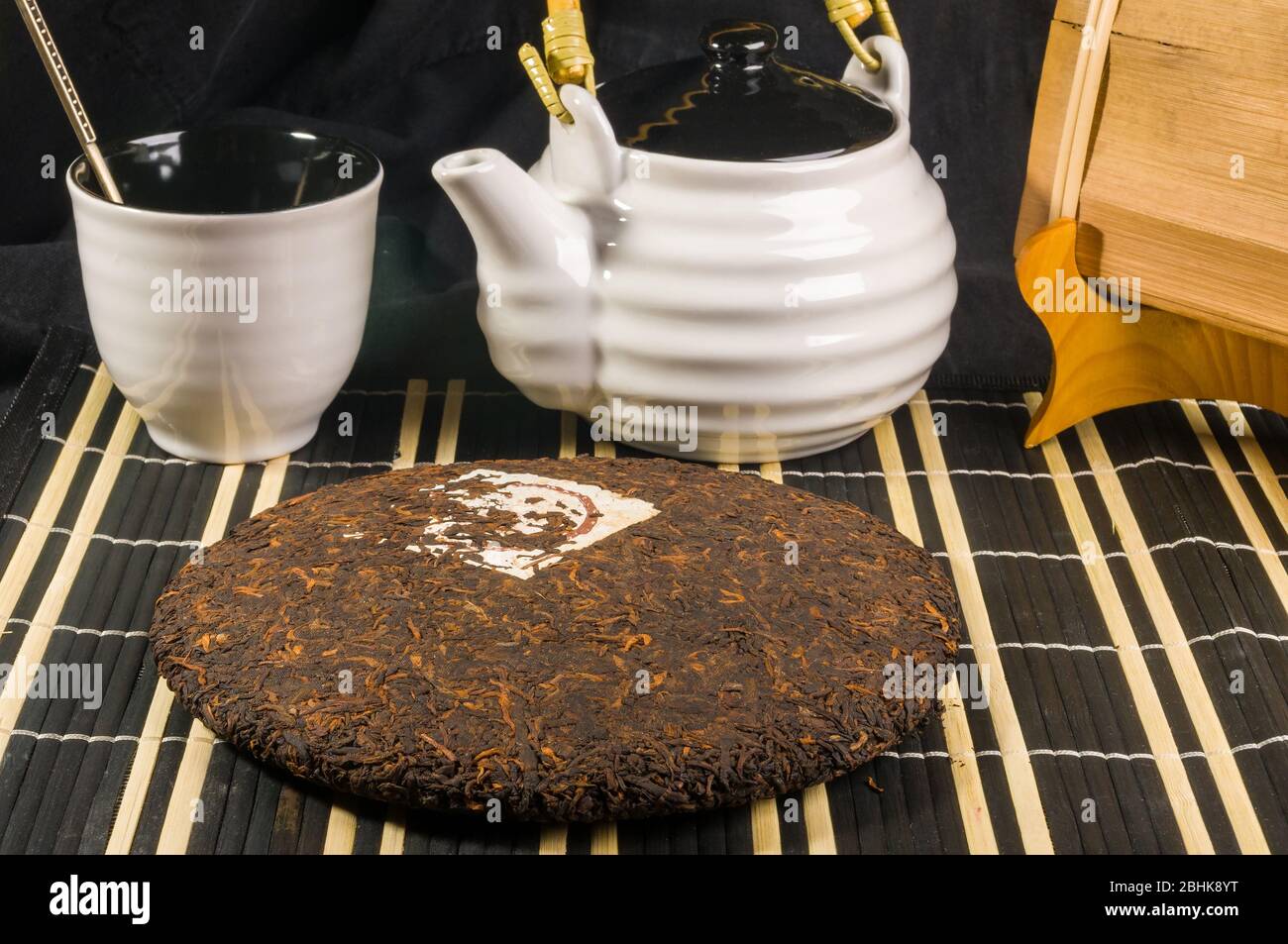 Chinese pressed PU-erh tea in bamboo leaf packaging and tea accessories ...