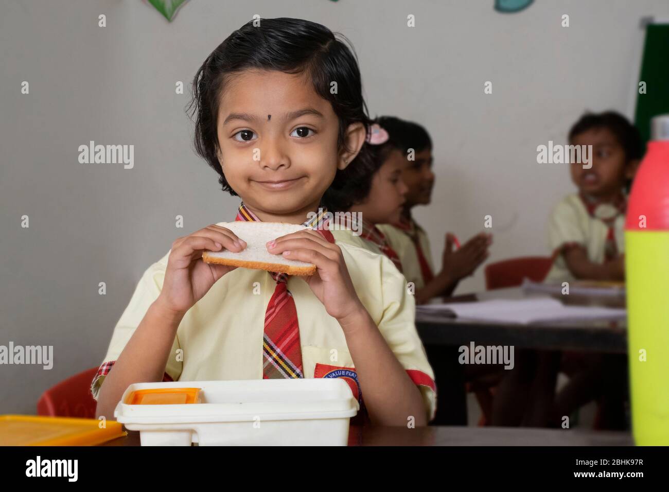 Elementary school girls eating at school lunch table Stock Photo - Alamy