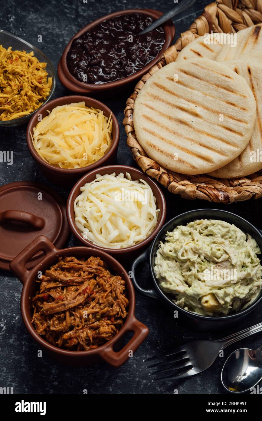 Latin arepas with various ingredients around such as meat, chicken ...
