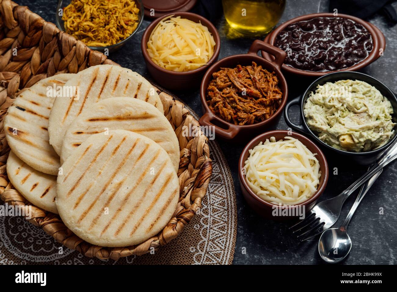 Latin arepas with various ingredients around such as meat, chicken ...