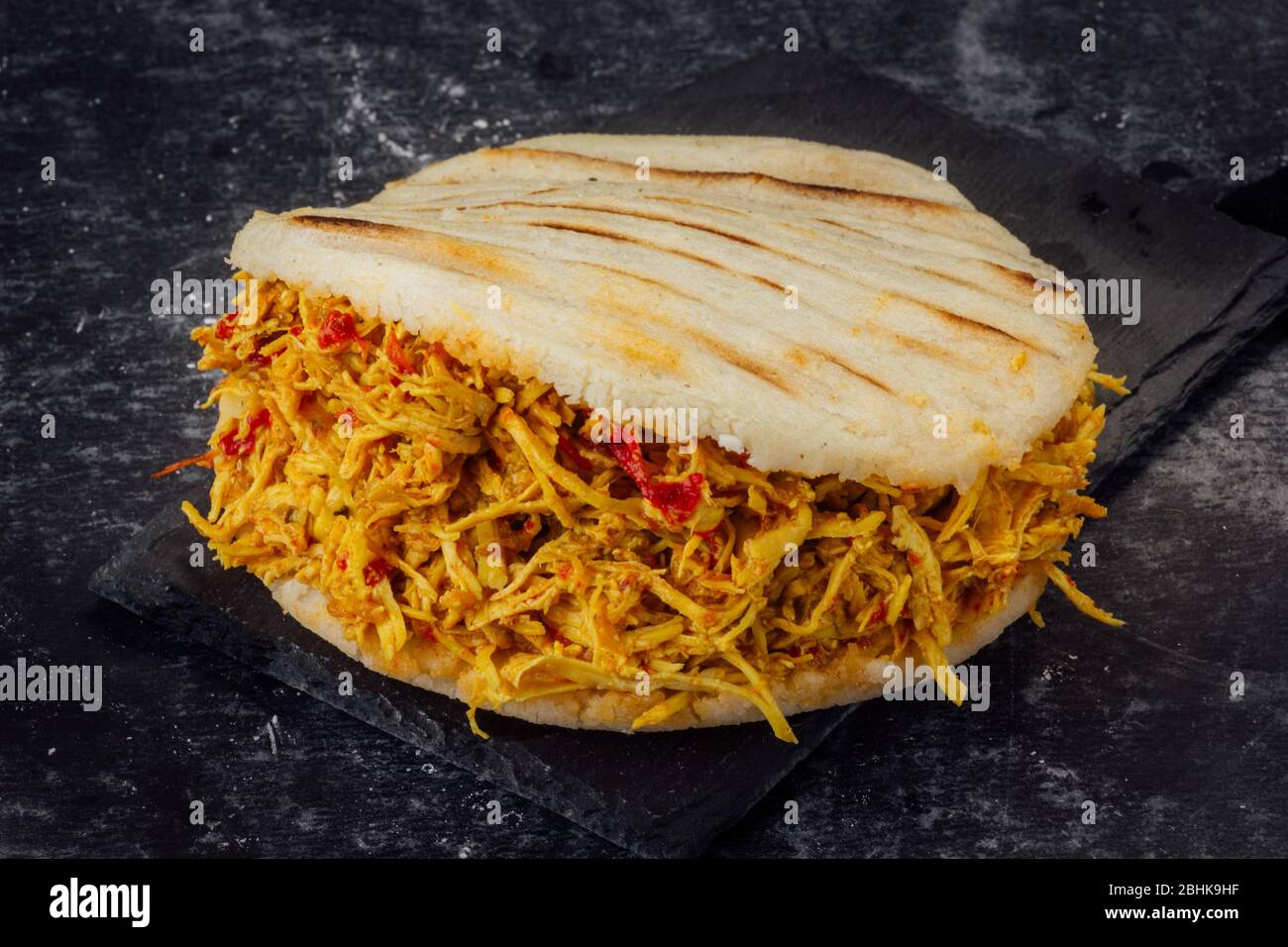 Arepa with chicken in strips. (Arepa pelua) Venezuelan typical food ...