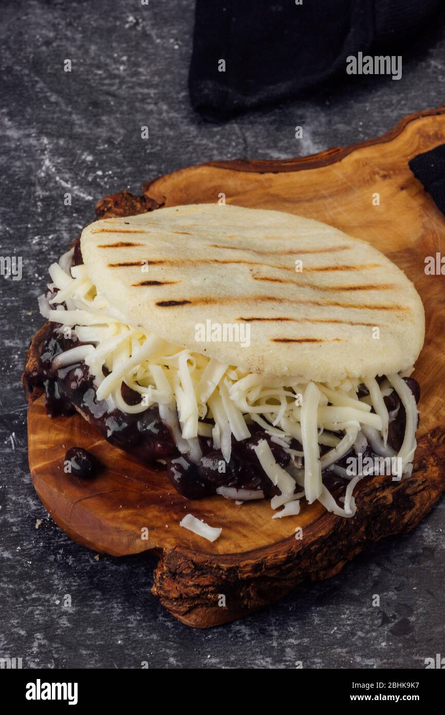 Arepa with black beans and white cheese. (Arepa domino Stock Photo - Alamy