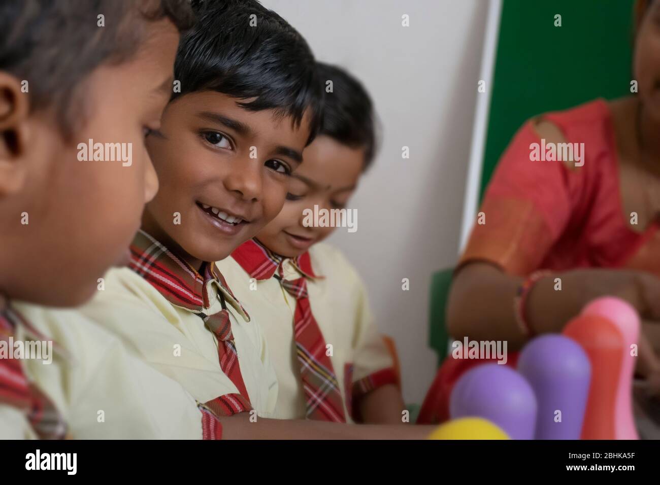 Young primary or elementary school children learning and playing desk ...