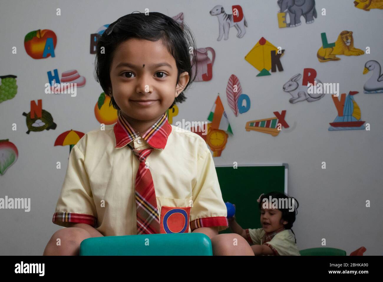 Young primary or elementary school children learning and playing desk ...