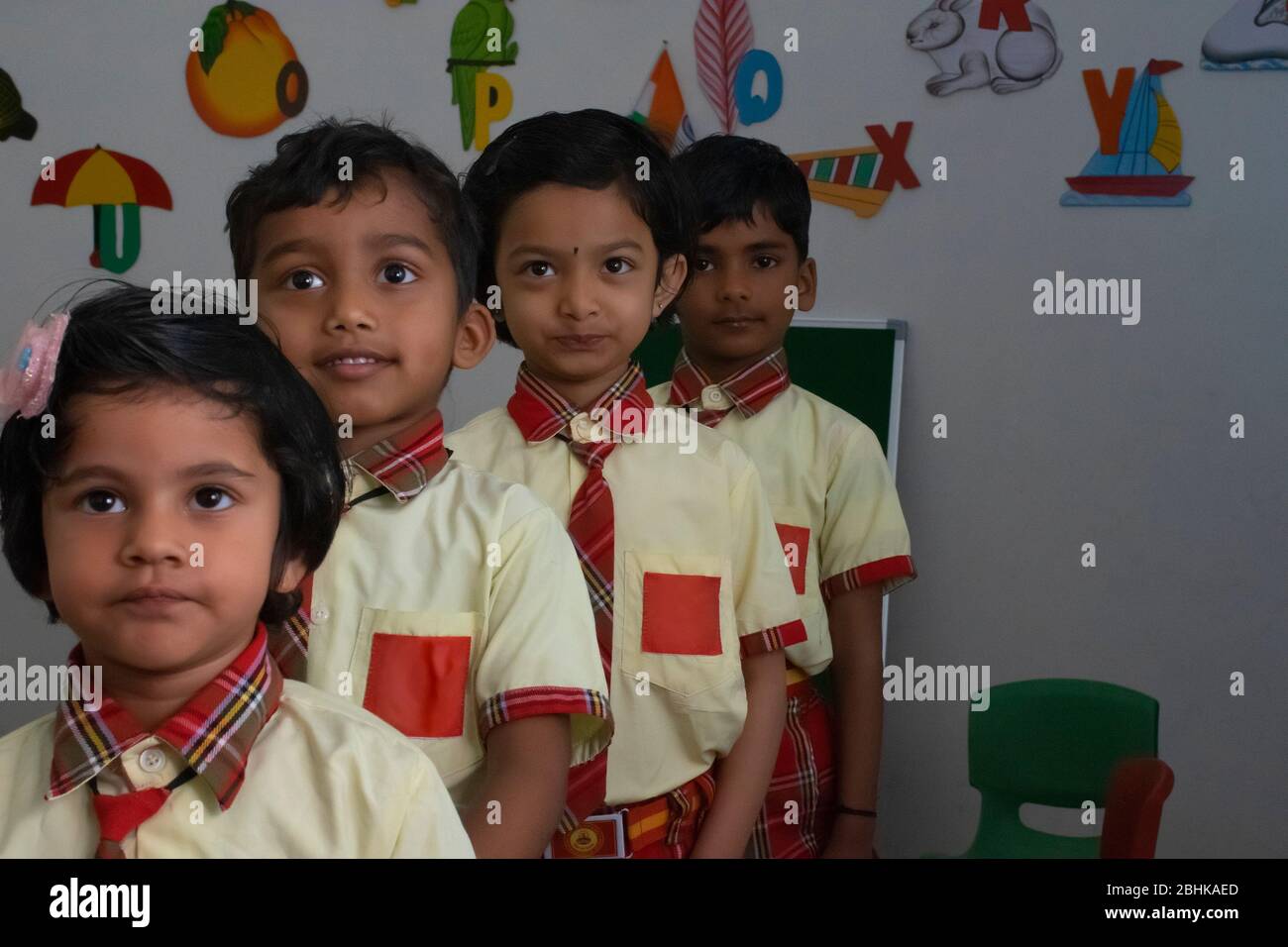 Young primary or elementary school children standing in line in a ...