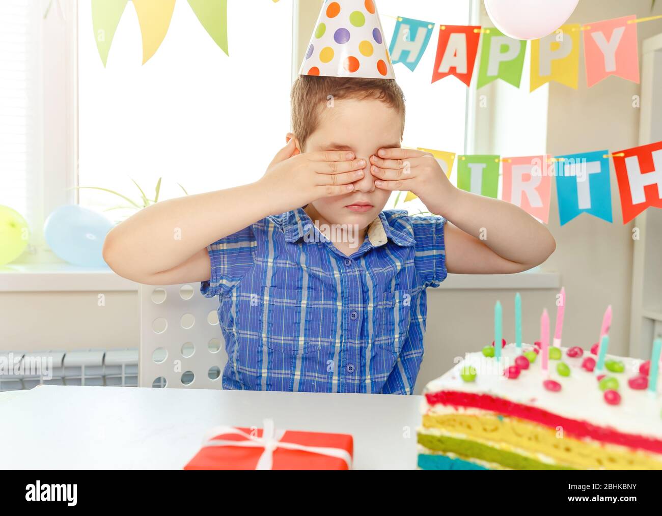 Cute boy surprised birthday cake. Child celebrates her birthday alone ...