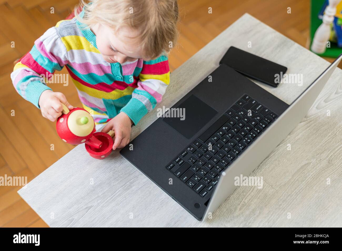 Cute blonde girl having a drink while working on a computer Stock Photo ...