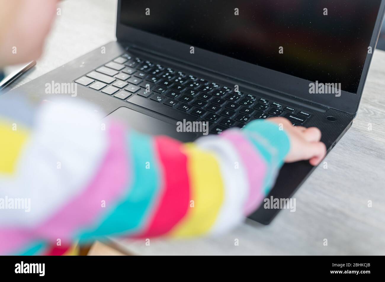 Side view of blonde girl using laptop computer Stock Photo - Alamy