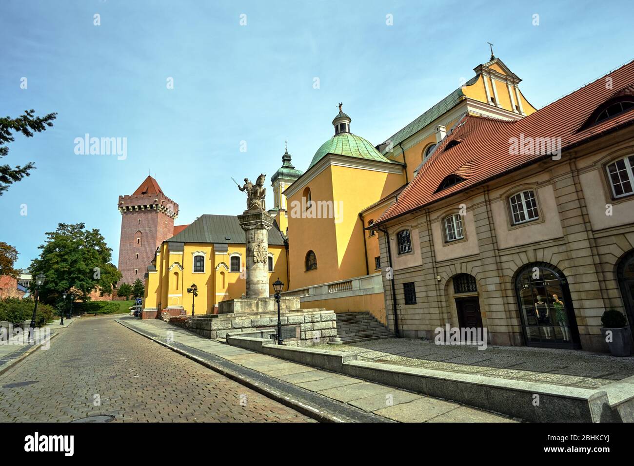 cobbled street with a statue of lancer and a historic church and a ...