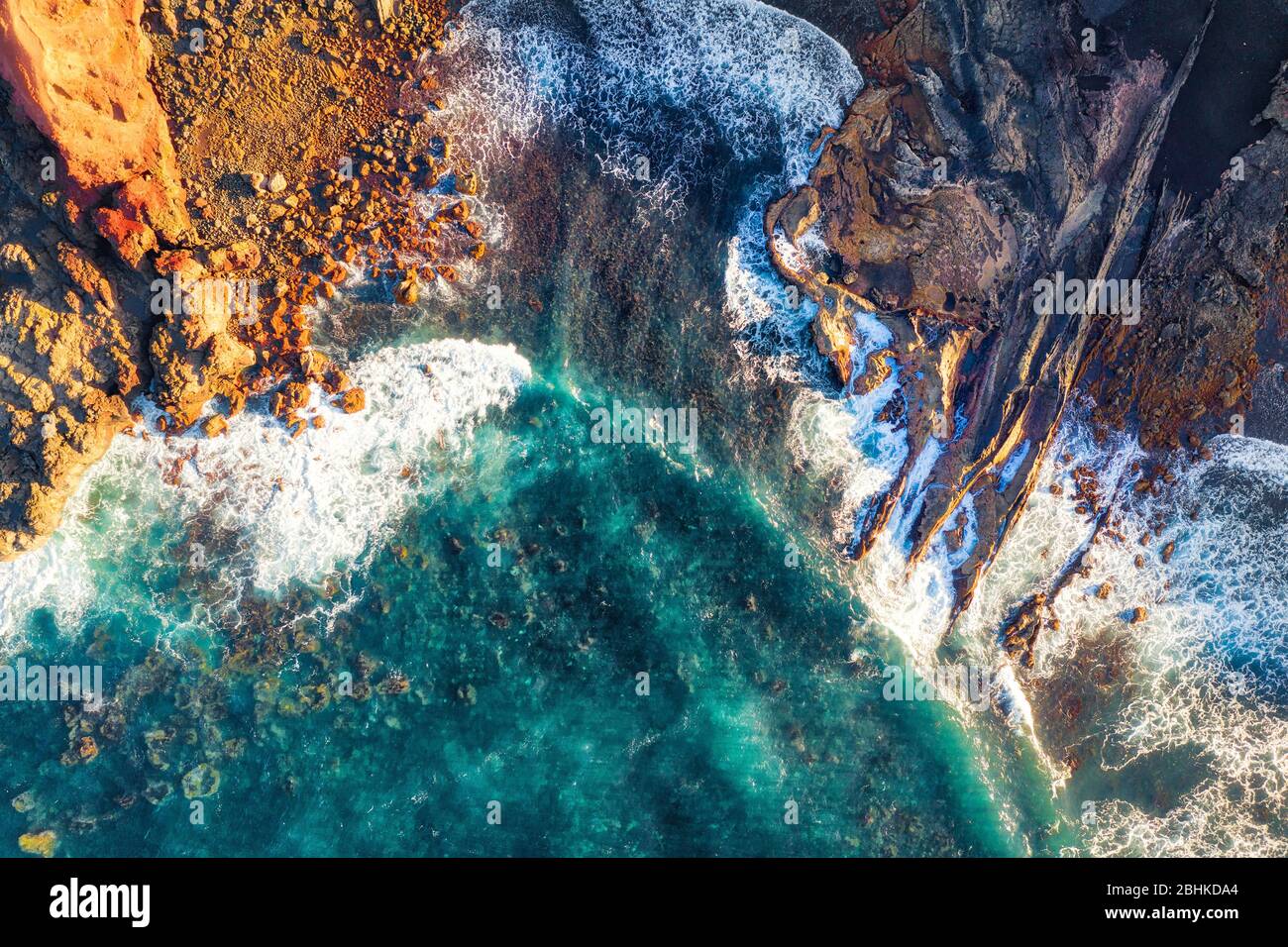Rocky coastline and highway with golden sand and blue water, post ...