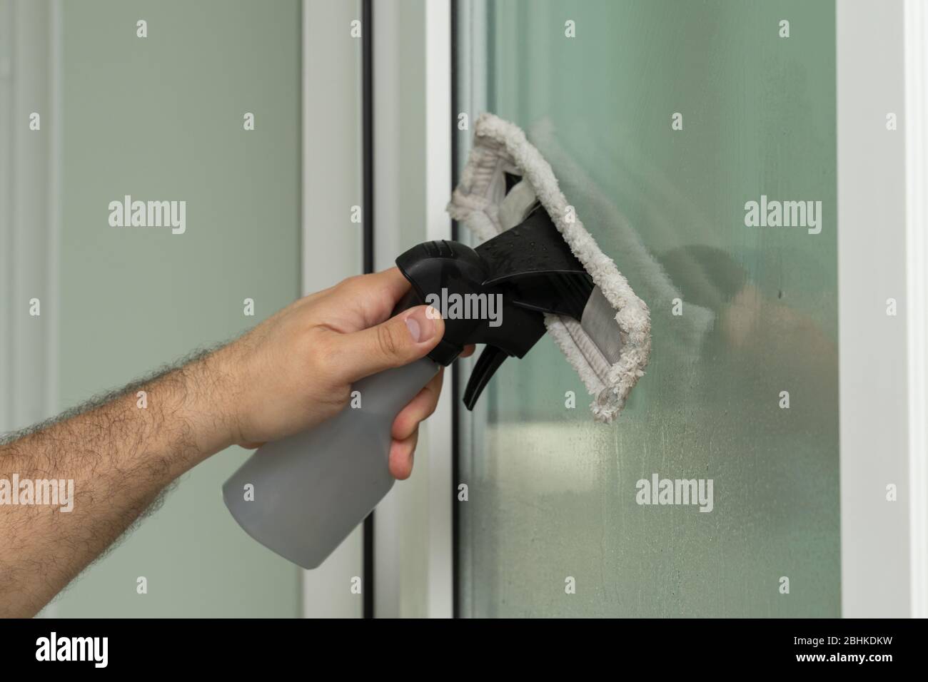 House cleaning. man's hand washes a window Stock Photo - Alamy