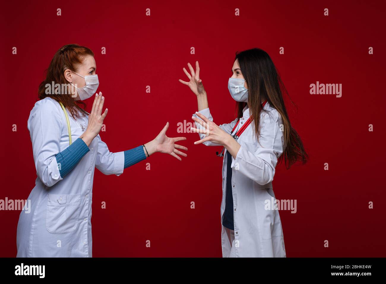 Portrait of two female doctors in medical clothes with phonendoscope ...