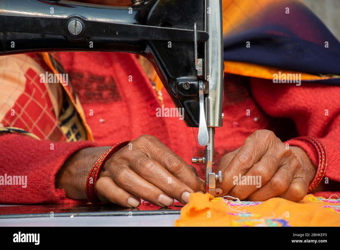 Women putting thread in her sewing, Tailoring Process Stock Photo - Alamy