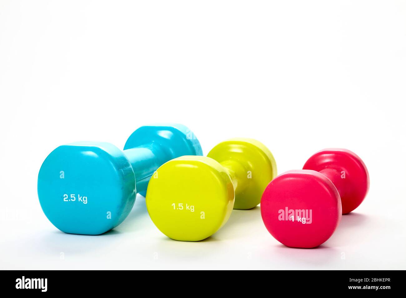 Three dumbbells isolated on a white background Stock Photo - Alamy