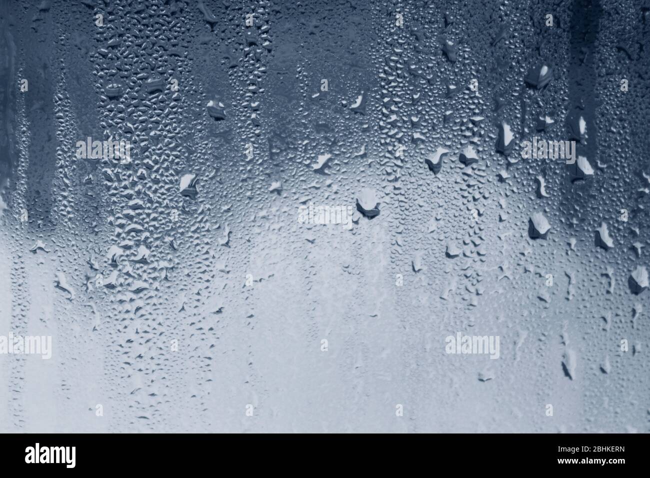 Drops of water flow down the fogged window glass Stock Photo - Alamy