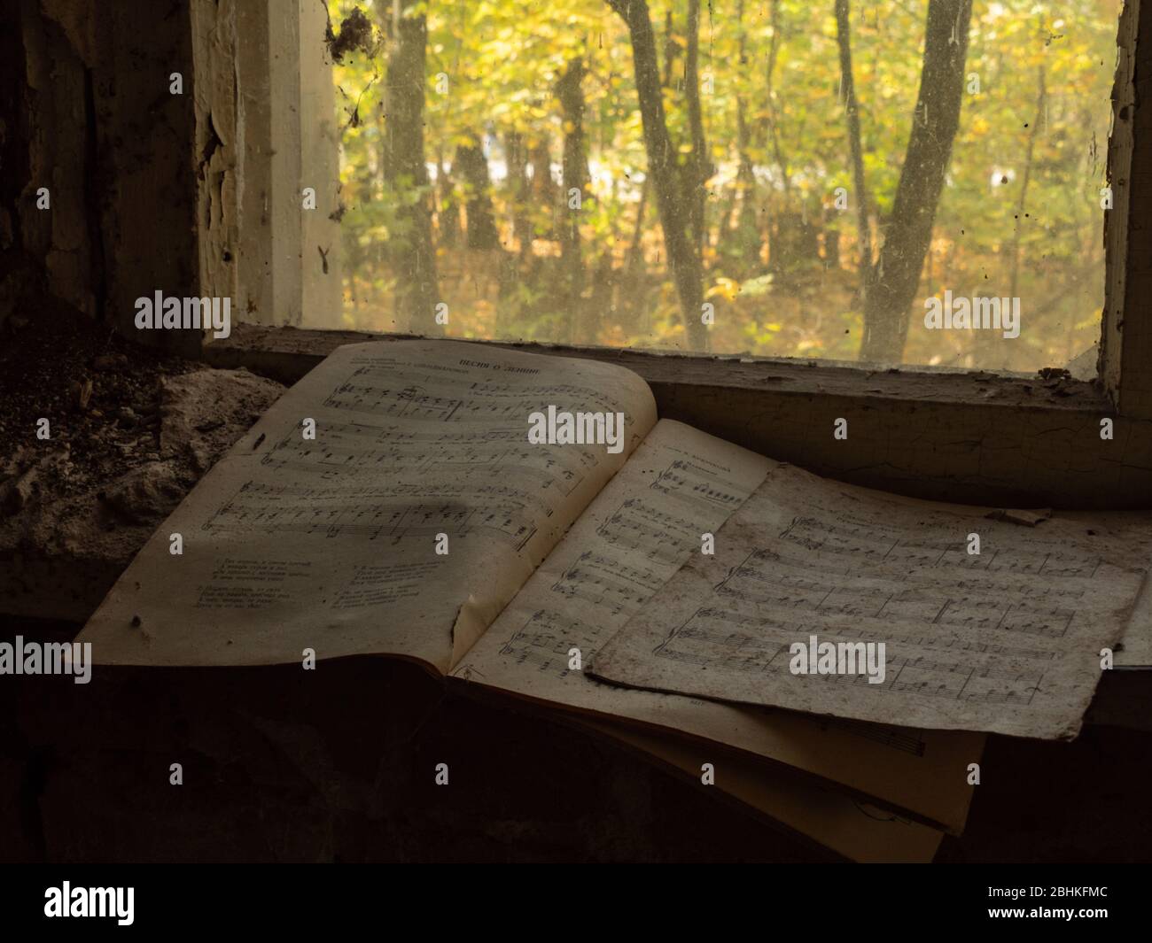Dirty notebook with notes against the window in the abandoned ...