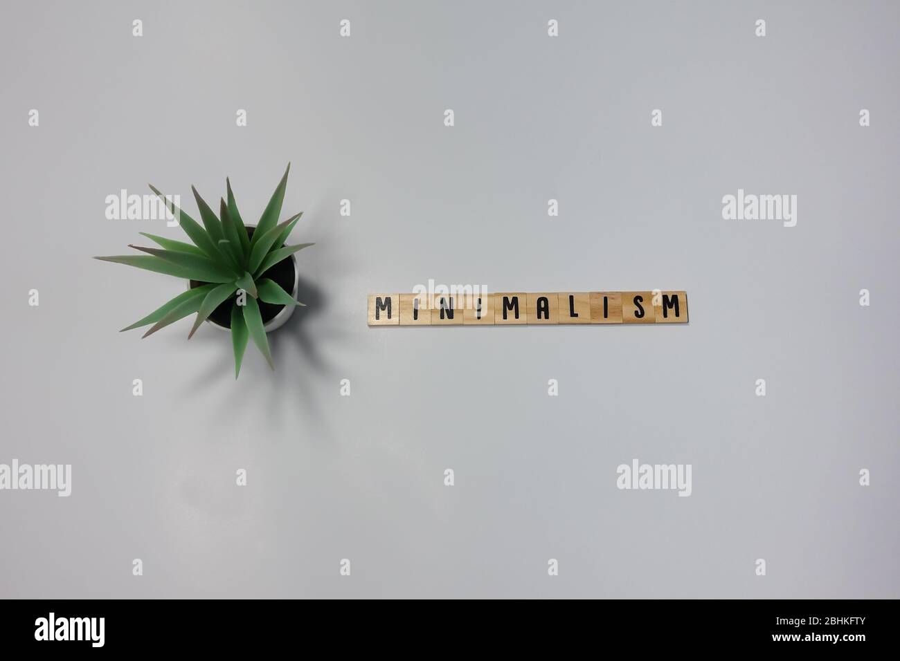 The word Minimalism written in wooden letter tiles on a white ...