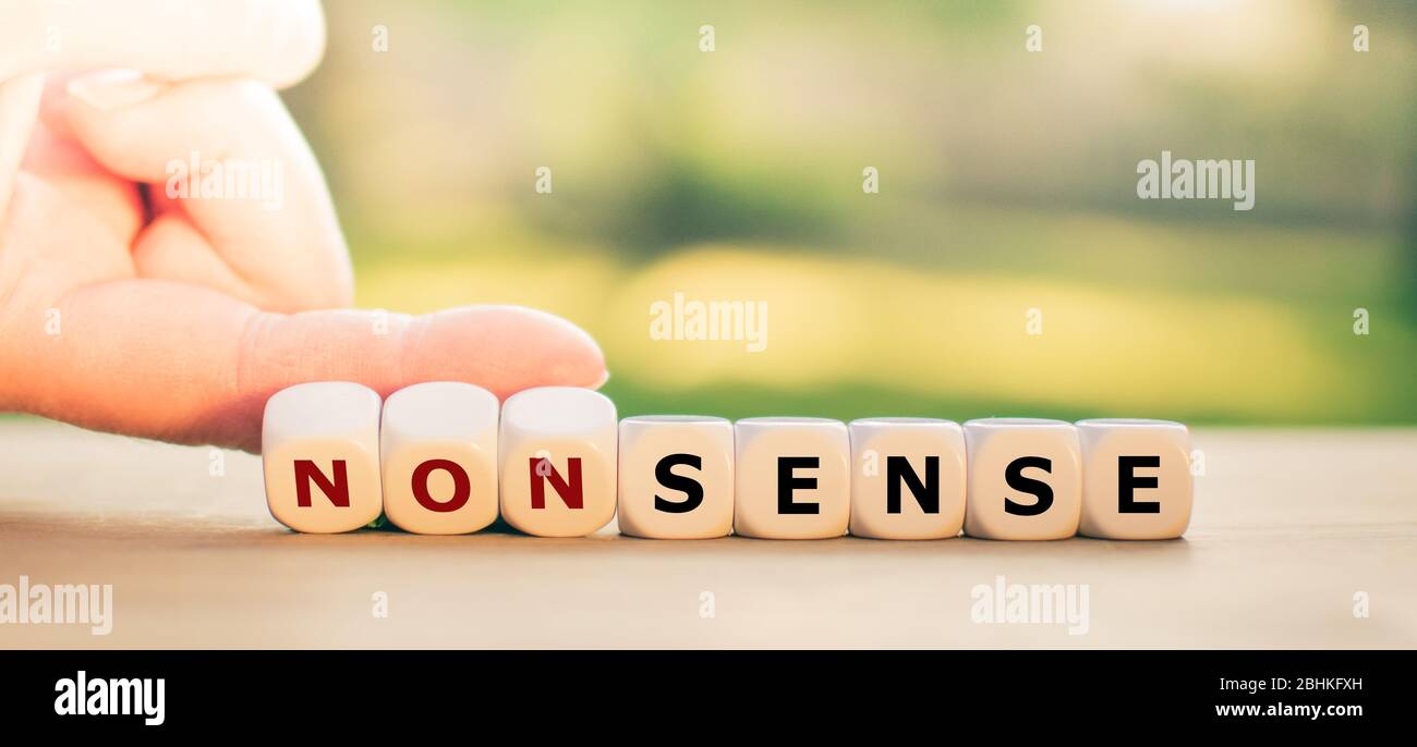 Hand turns dice and changes the expression "non sense" to "sense Stock ...