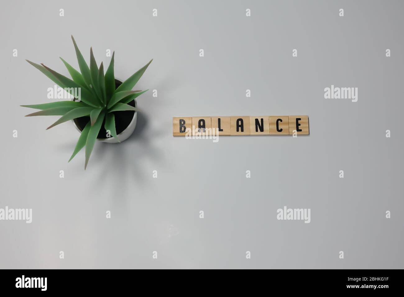 The word Balance written in wooden letter tiles on a white background ...