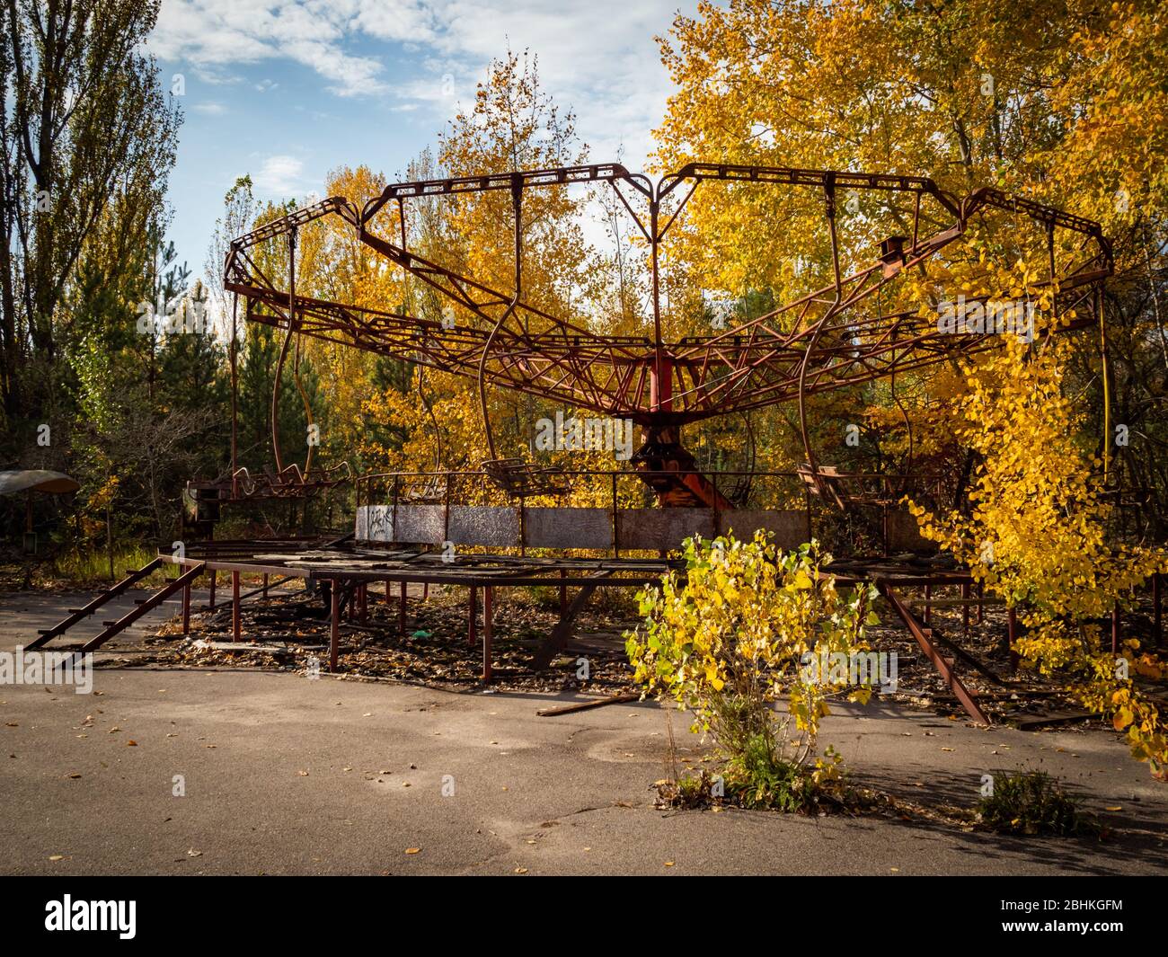 Abandoned amusement park in ghost town Pripyat. Overgrown trees and ...