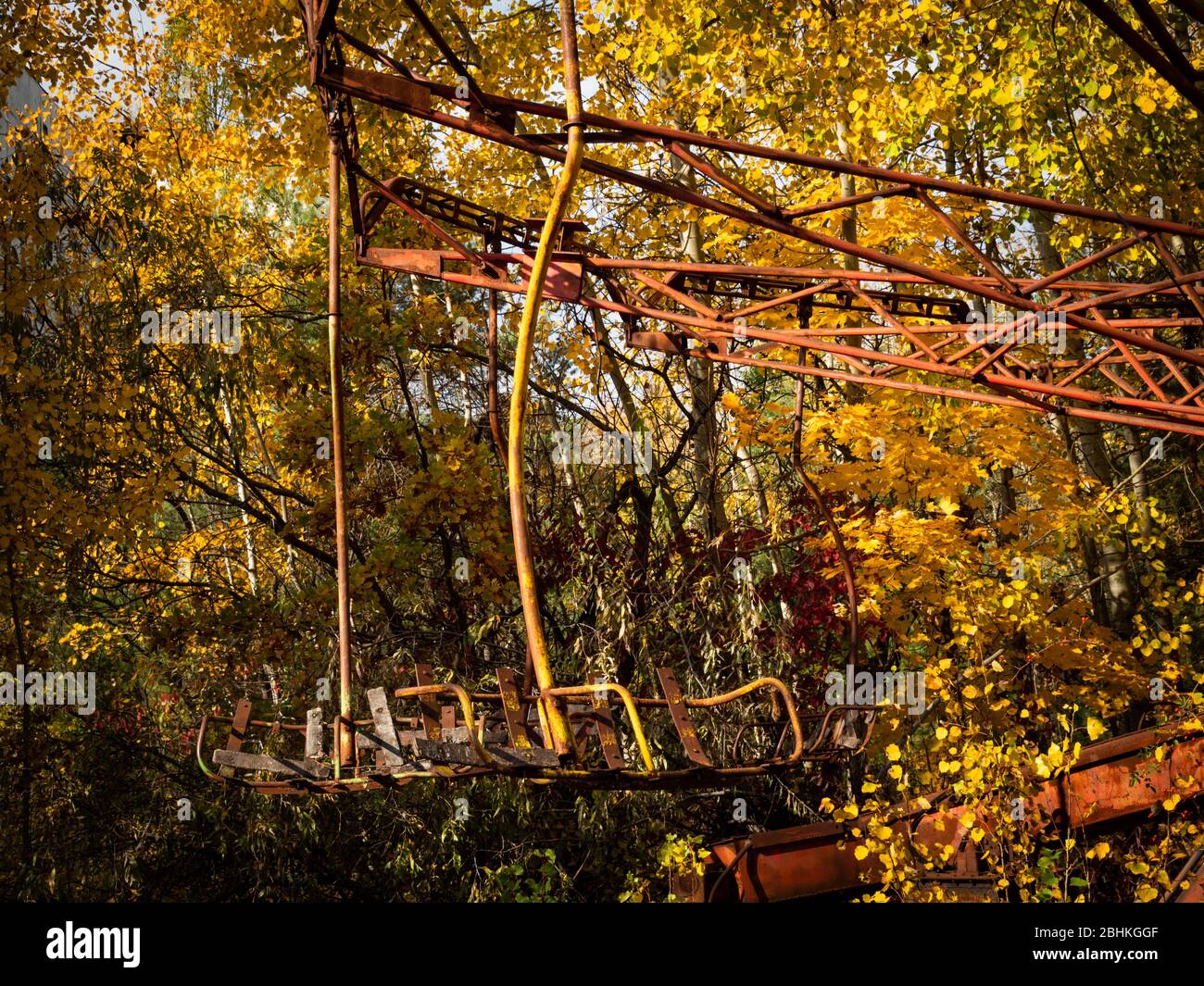 Abandoned amusement park in ghost town Pripyat. Overgrown trees and ...