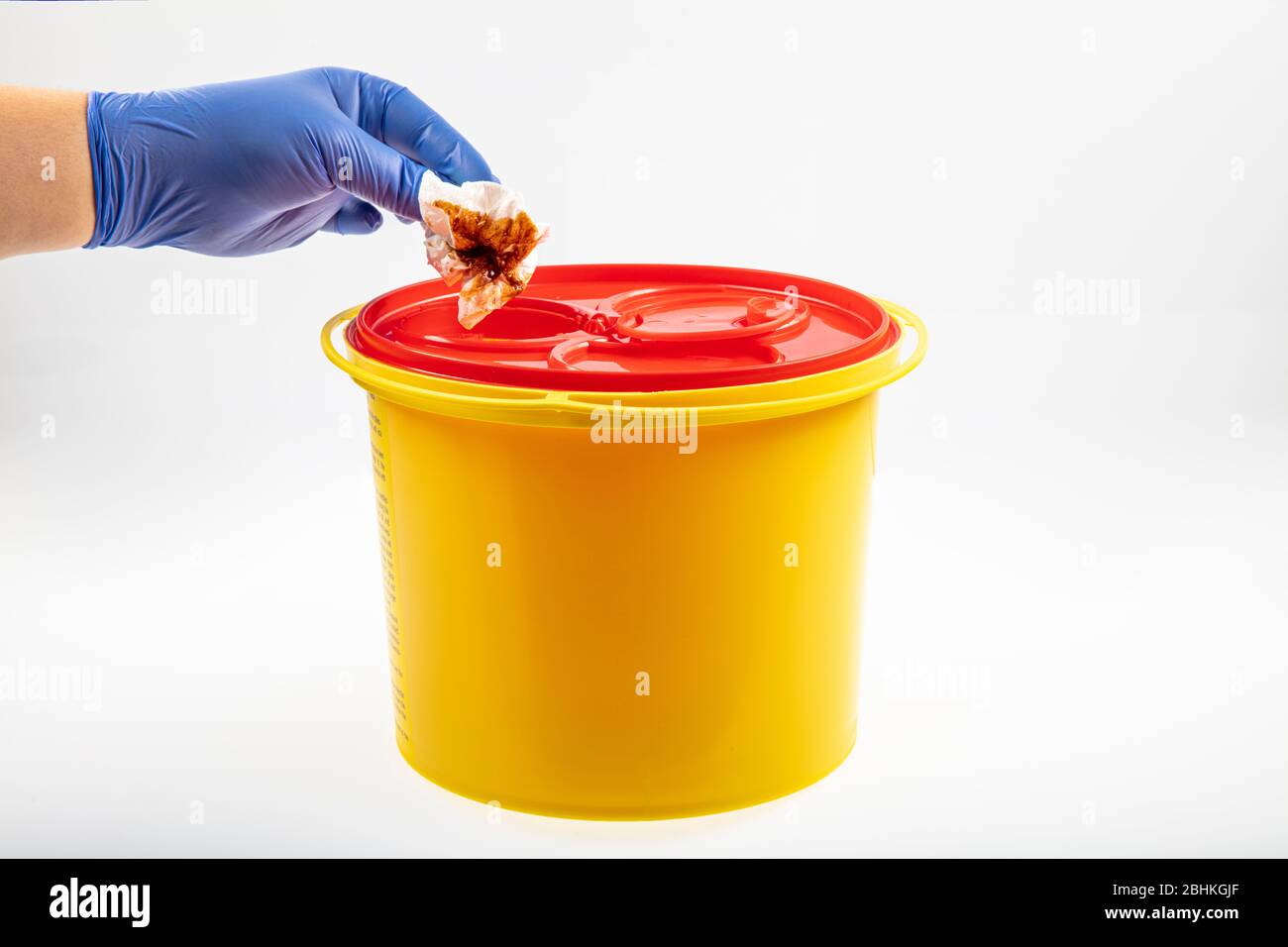 Health worker throws sharp waste into the medical waste bin. Medical ...