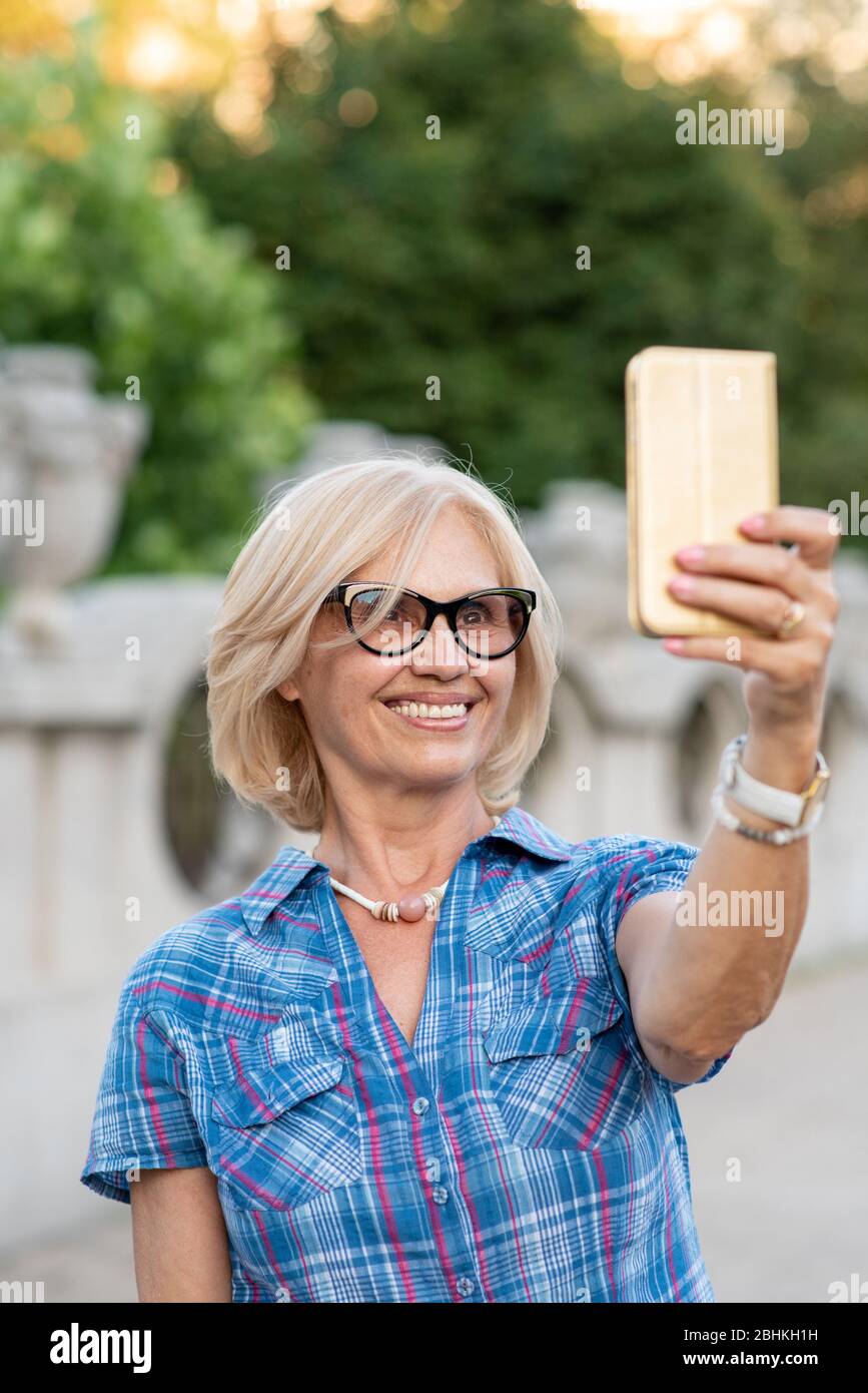 Smiling blonde glasses taking selfie hi-res stock photography and ...