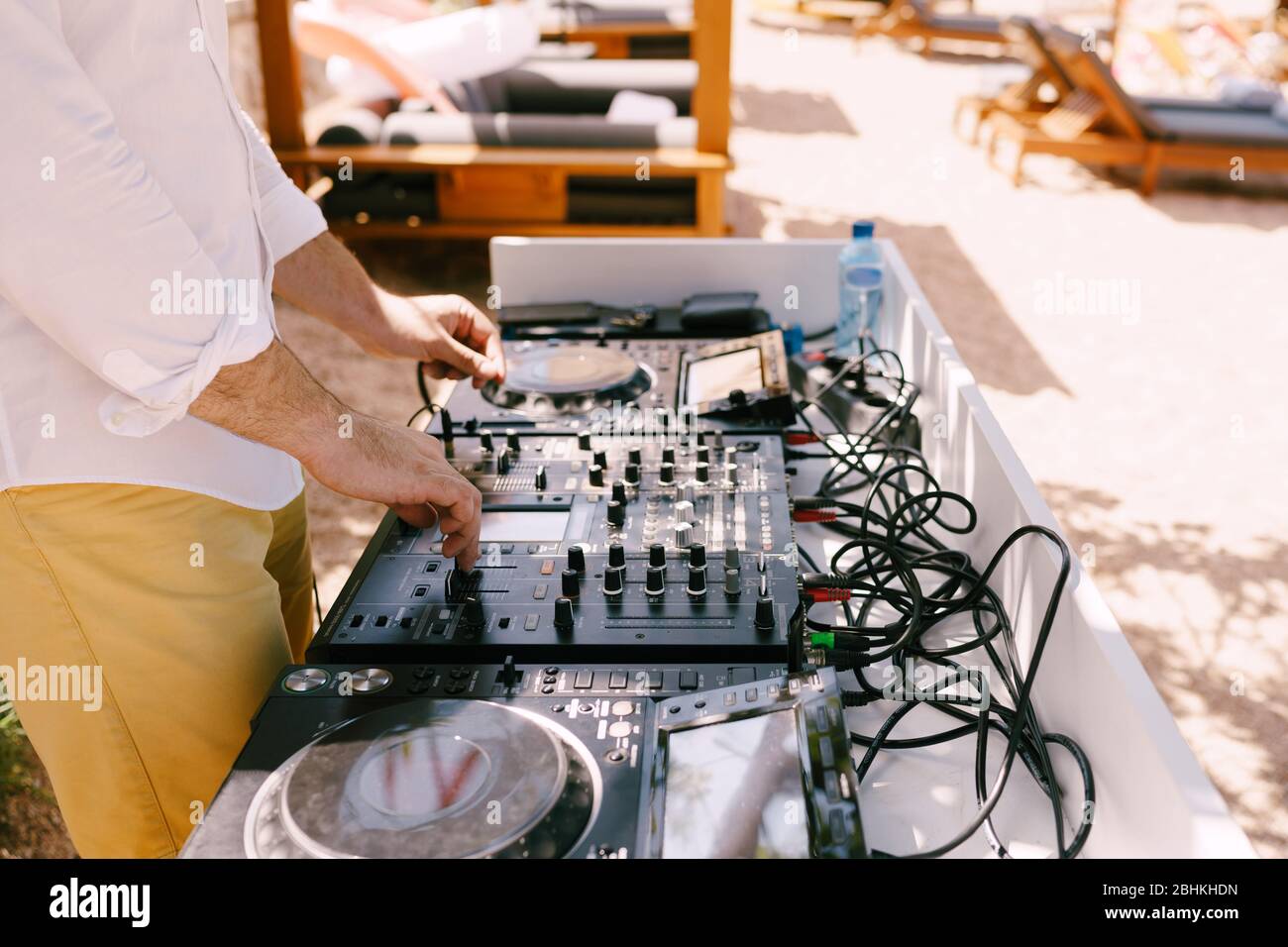 DJ plays music on the beach. Dj mixing beach party in summer vacation ...