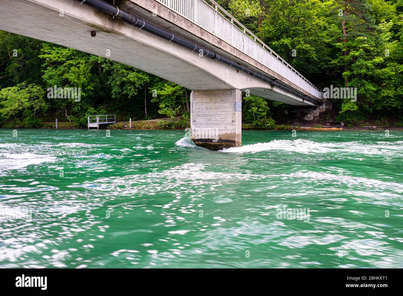 Concrete bridge over the river in a beautiful turquoise color, visible ...
