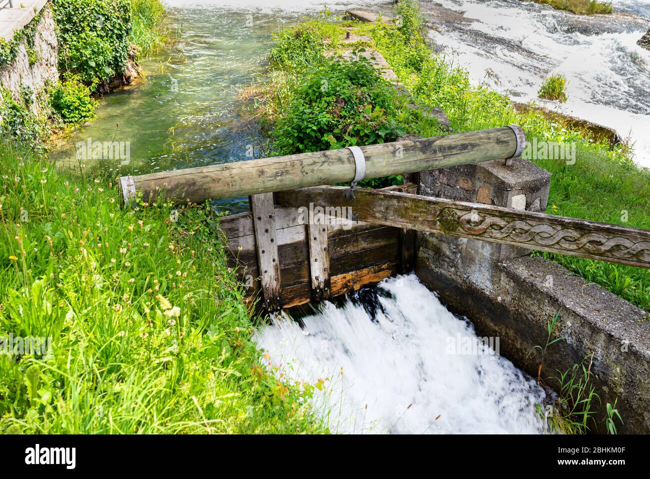 A small dam on the river basin made of wood that requires manual ...